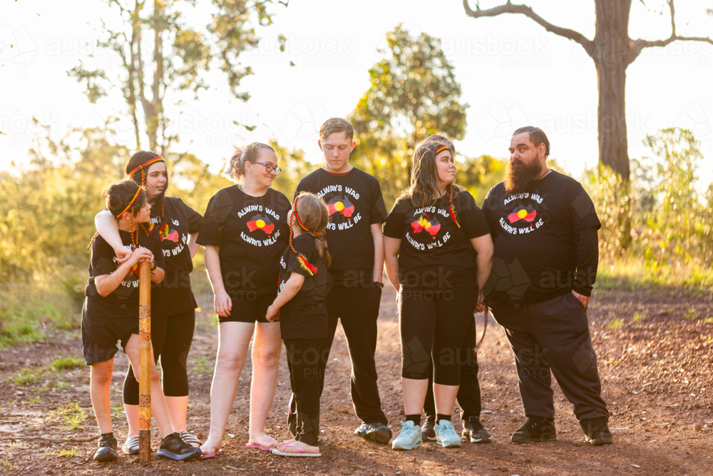 Image of Aboriginal family standing together in golden light in ...