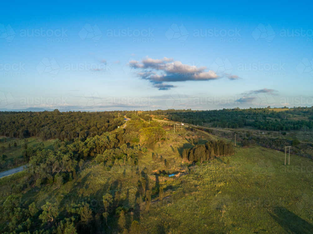 Image of Aerial view of landscape beside golden highway with power ...