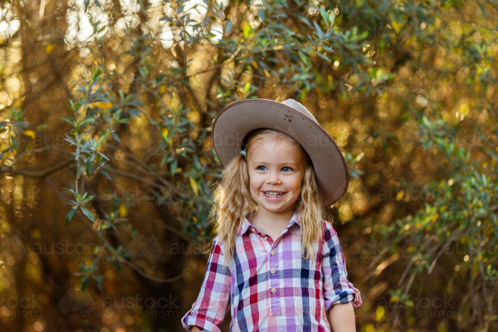 Image of Happy smiling country kid in mud splattered Australian bush ...