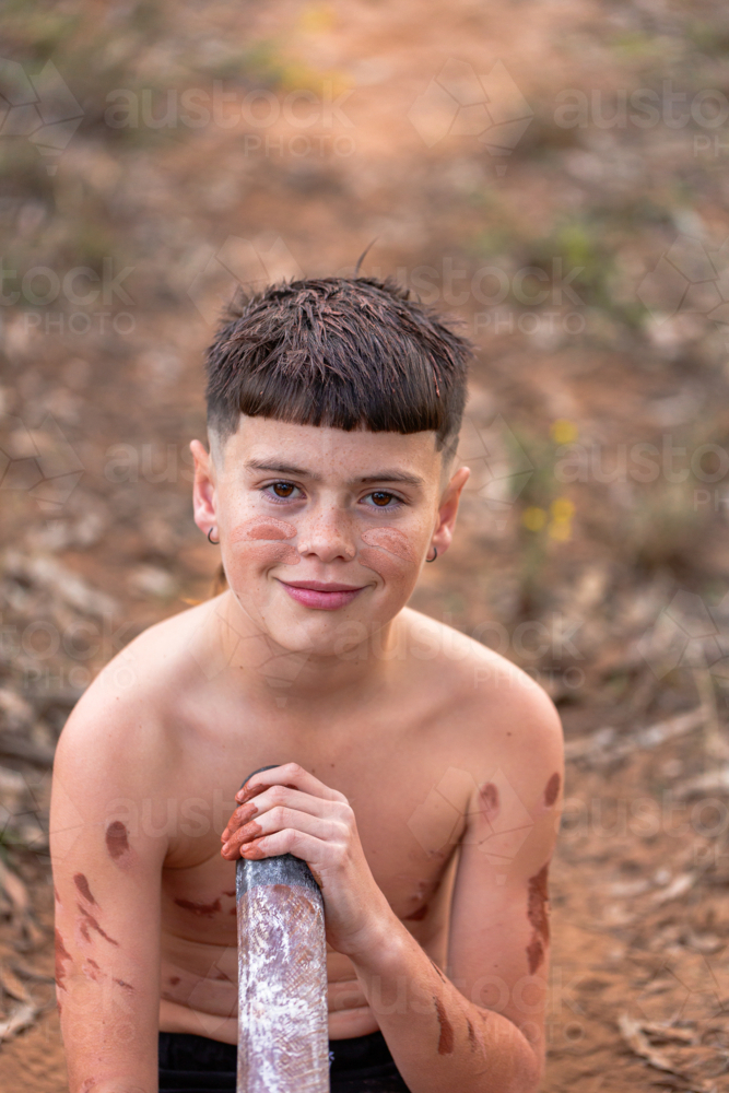 Image of Portrait of First Nations Australian kid holding didgeridoo ...