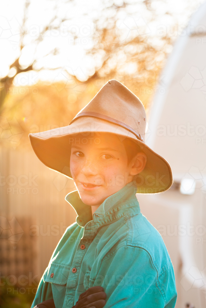 Image of Portrait of young Australian boy in backyard with akubra hat ...