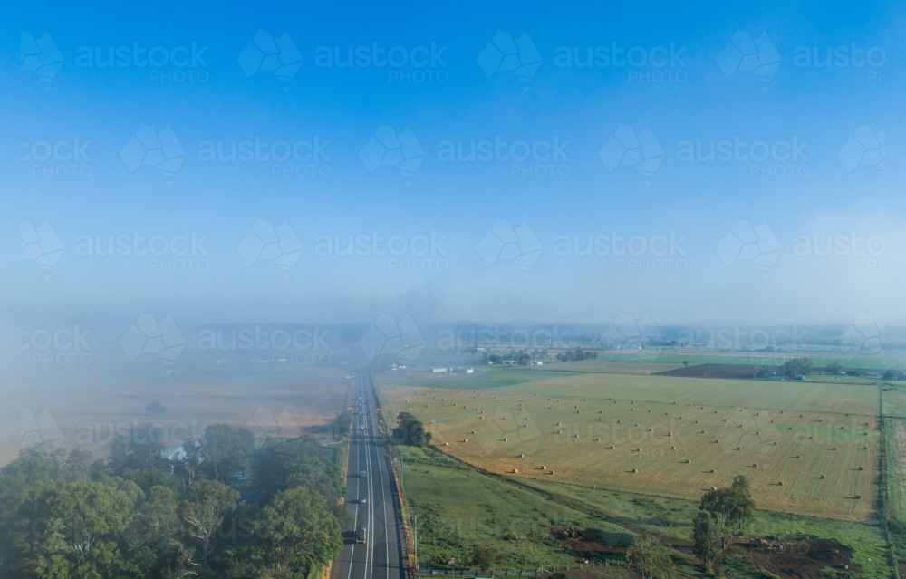 Image of Thin mist over highway through paddocks of agricultural ...