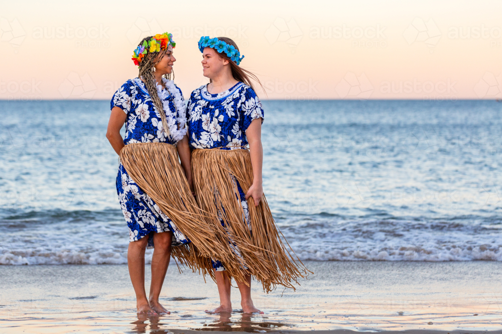 Image of Torres Strait Islander mum with teenaged daughter looking at each other by the ocean at ...