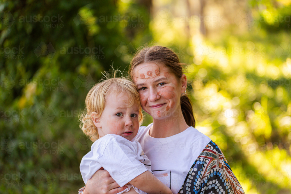 Image of Two aboriginal siblings happy big sister and worried little ...